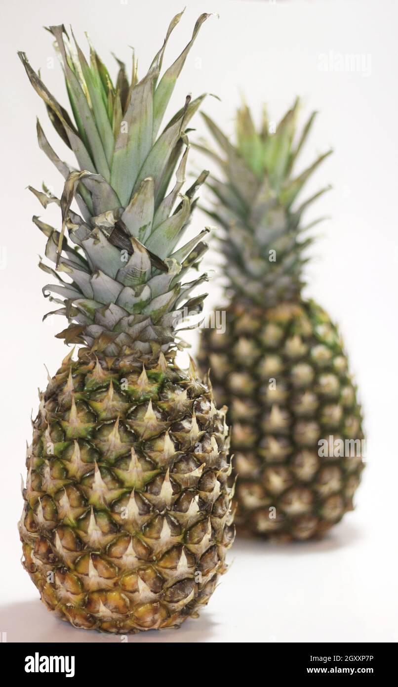Two Pineapples on light background Stock Photo - Alamy