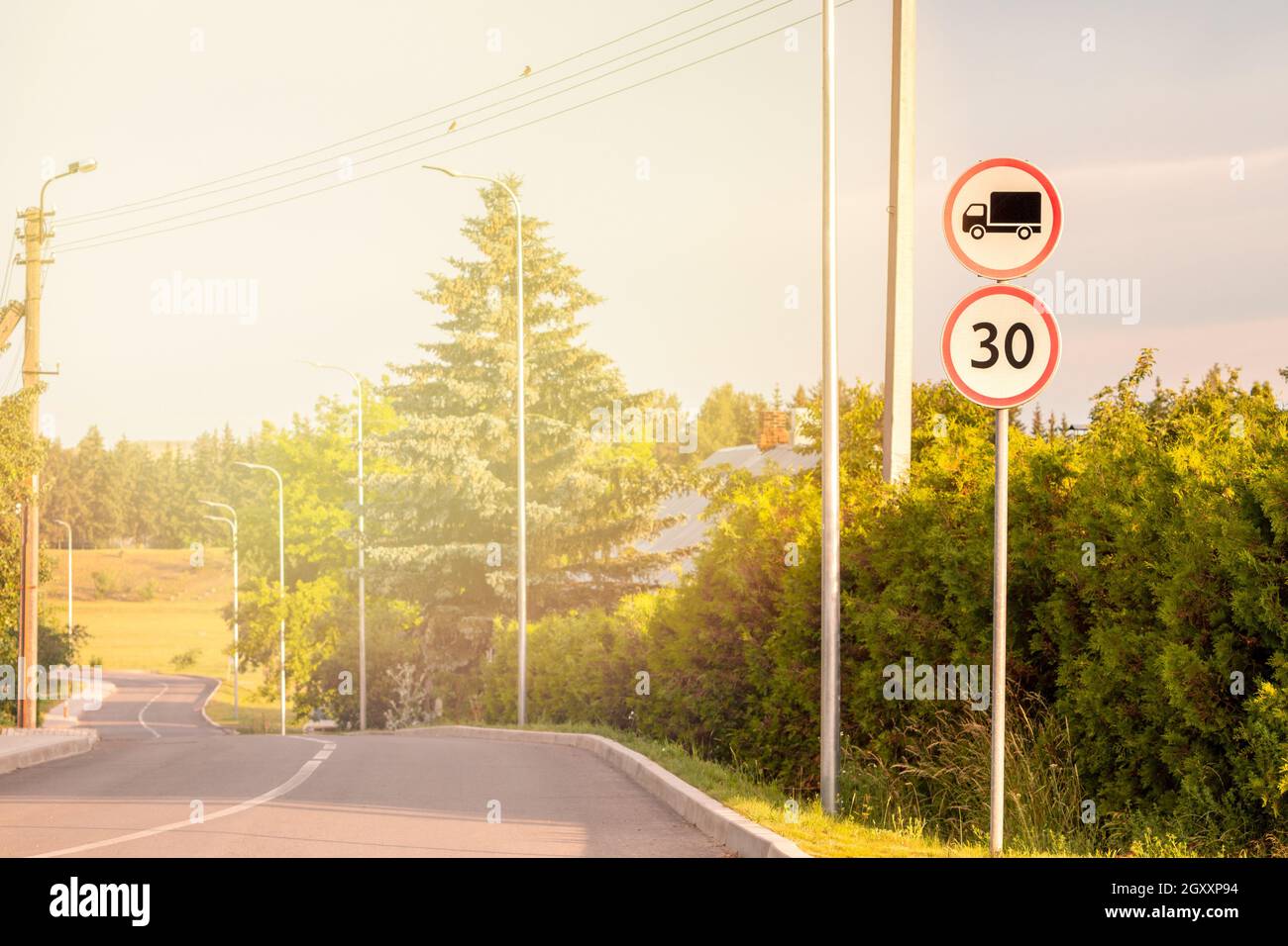 No goods vehicles and road with speed limit 30 warning signs Stock ...
