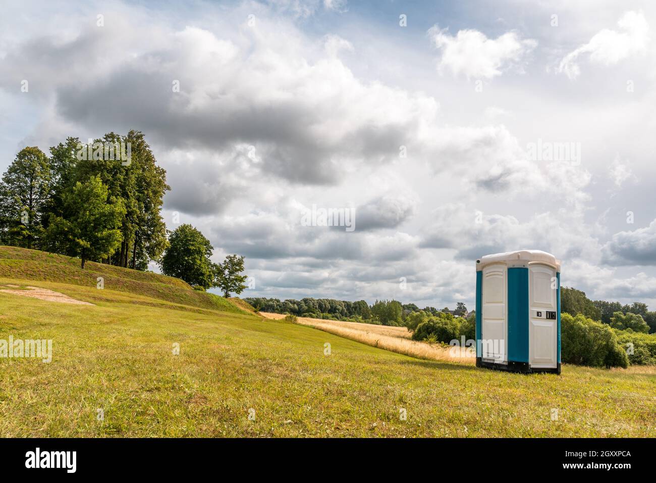 Temporary single portable plastic toilet on grass field Stock Photo - Alamy