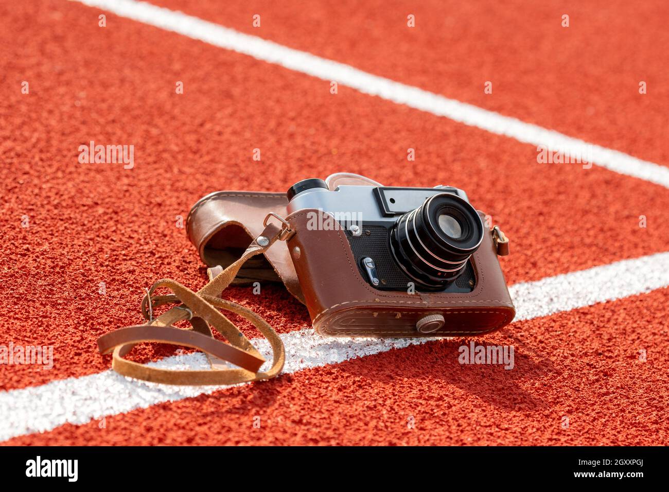 Retro camera on the running track in stadium, sport journalism concept ...