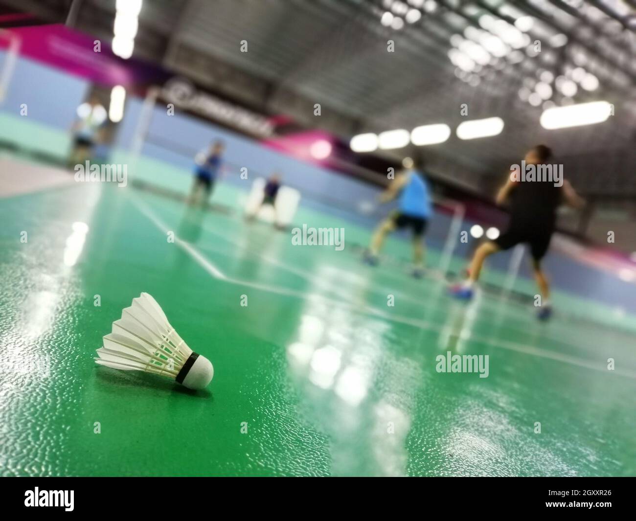 Shuttlecock at badminton courts with players competing Stock Photo - Alamy
