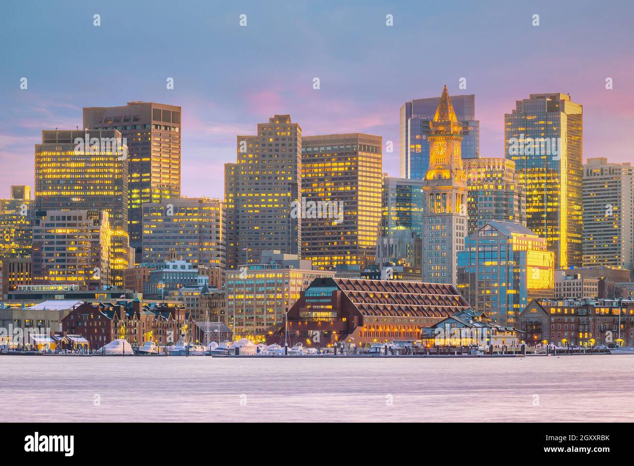 Panorama view of Boston skyline with skyscrapers over water at twilight ...