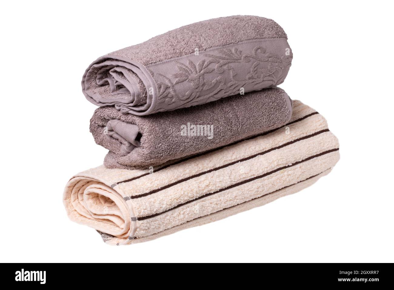Towels isolated. Closeup of a stack or pile of brown beige soft terry ...