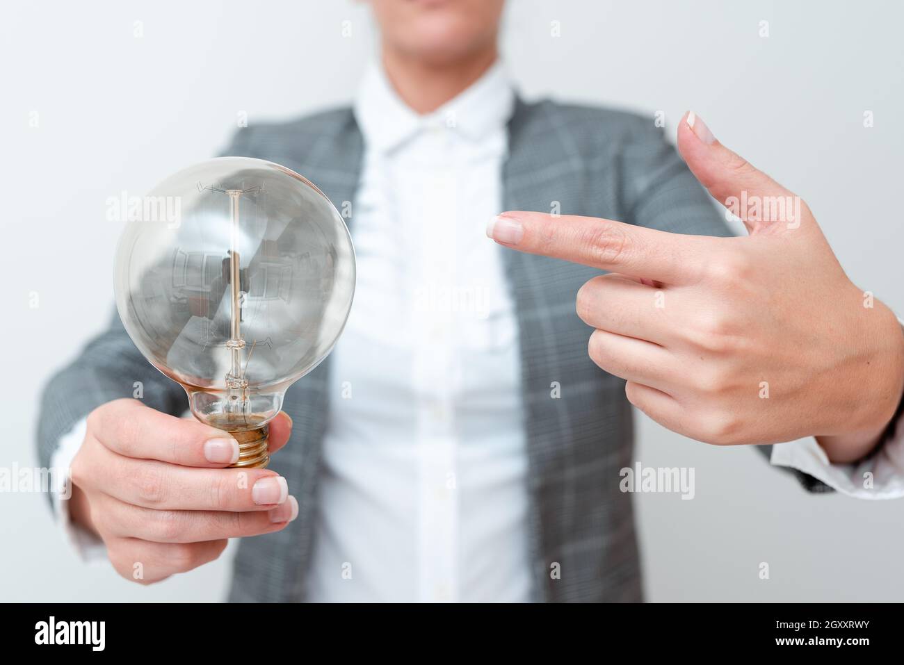 Lady Pointing To Lamp Held In Hand In Formal Outfit Presenting New ...