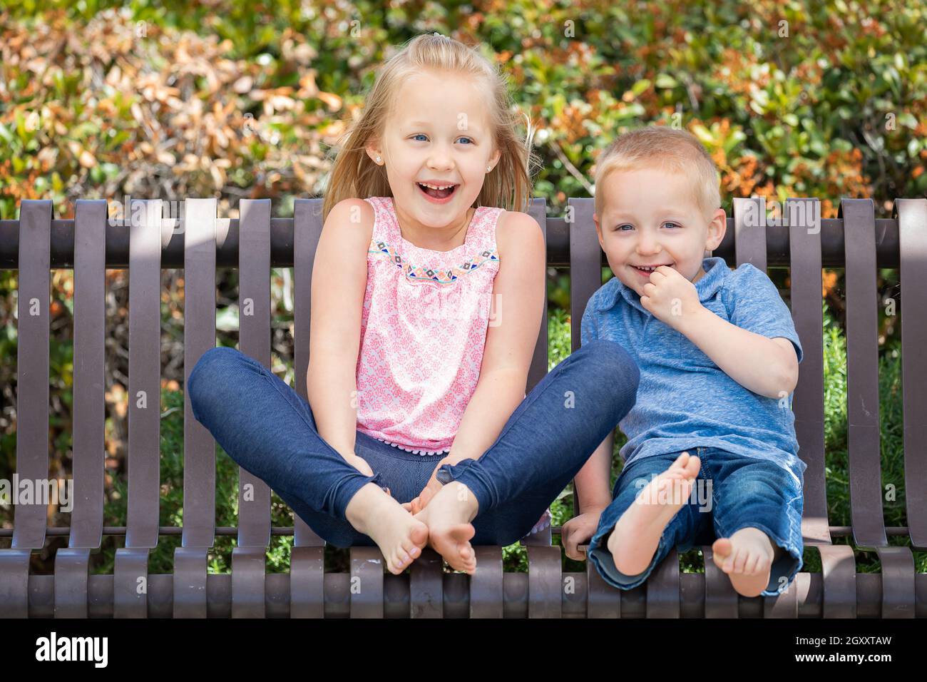 Young Sister and Brother Having Fun On The Bench At The Park Stock ...