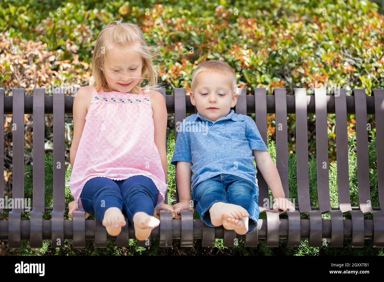 Young Sister and Brother Having Fun On The Bench At The Park Stock ...