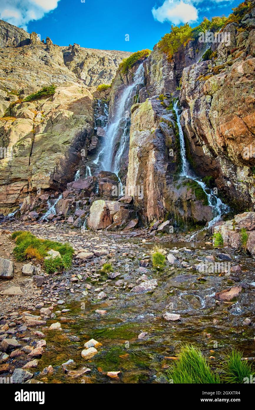 Large waterfall into stream up in mountains with mossy rocks Stock ...