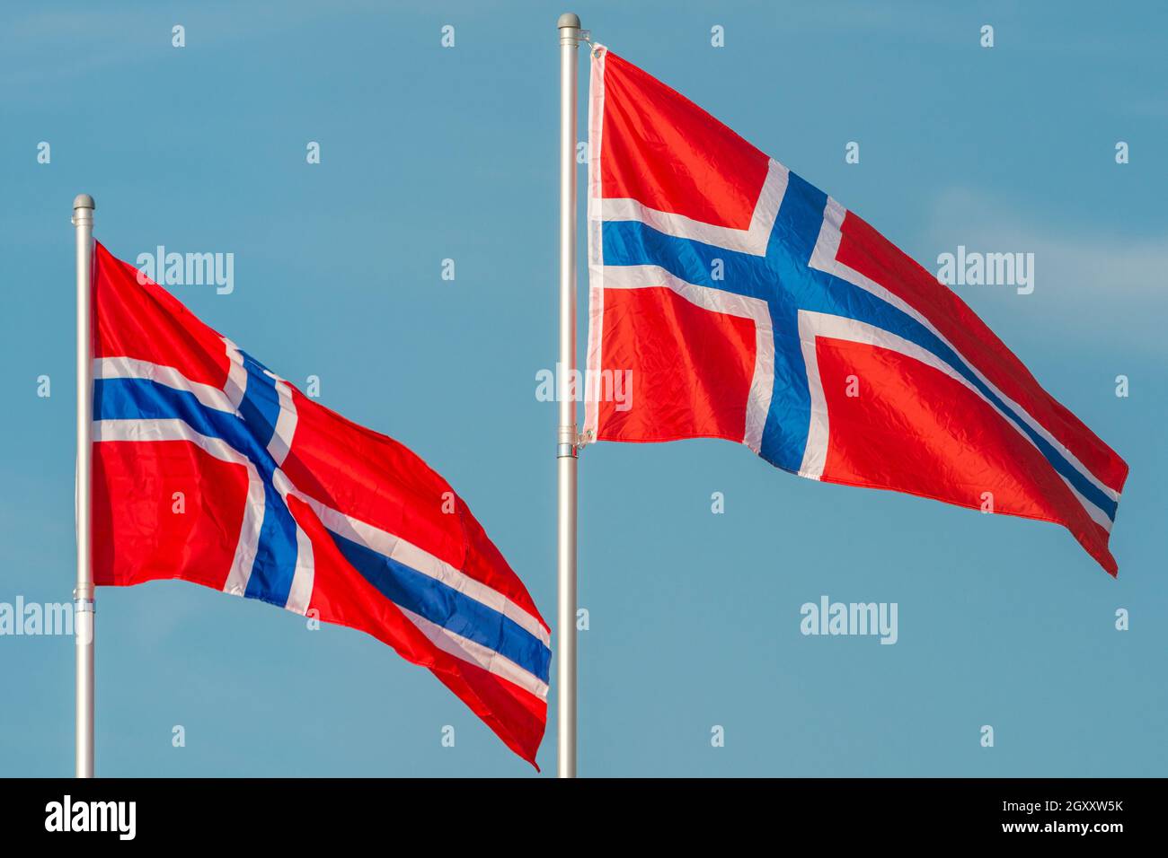 Norway flags blowing in the wind over nice blue sky background Stock ...