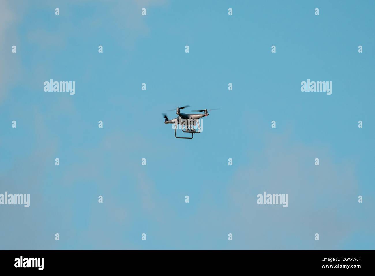 Drone quadcopter flying high in a sky Stock Photo - Alamy