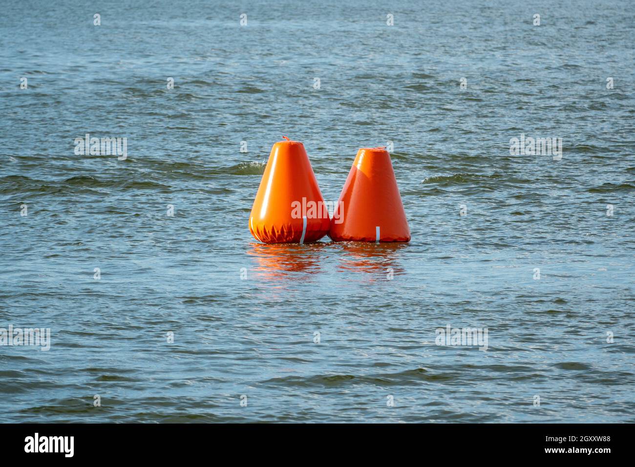 Two inflatable orange buoys in a lake. Safety in a water Stock Photo ...