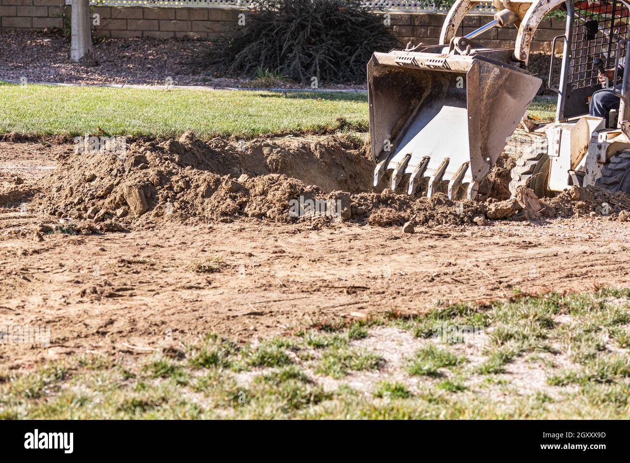 Small Bulldozer Digging In Yard For Pool Installation Stock Photo - Alamy