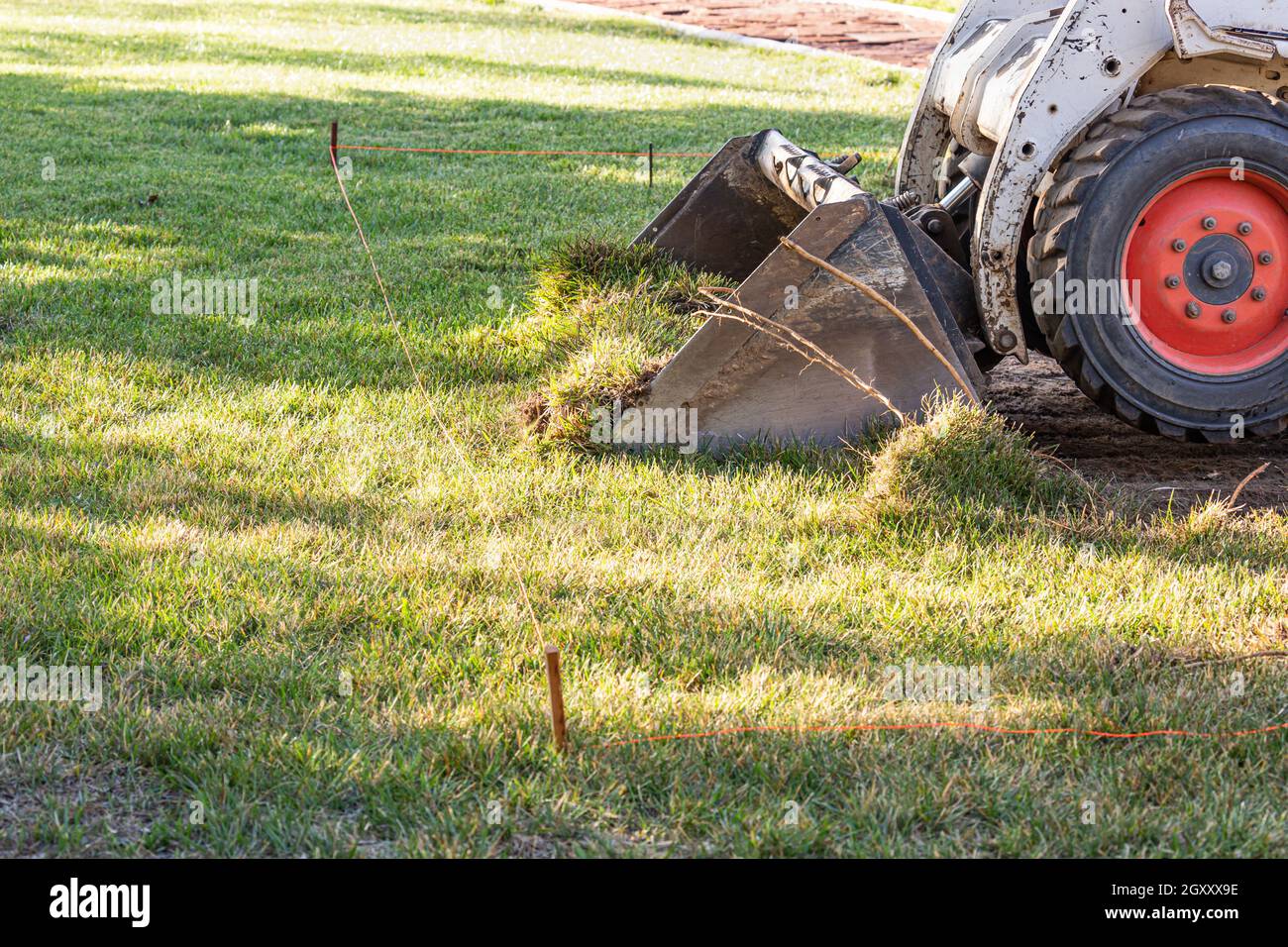 Small Bulldozer Removing Grass From Yard Preparing For Pool ...
