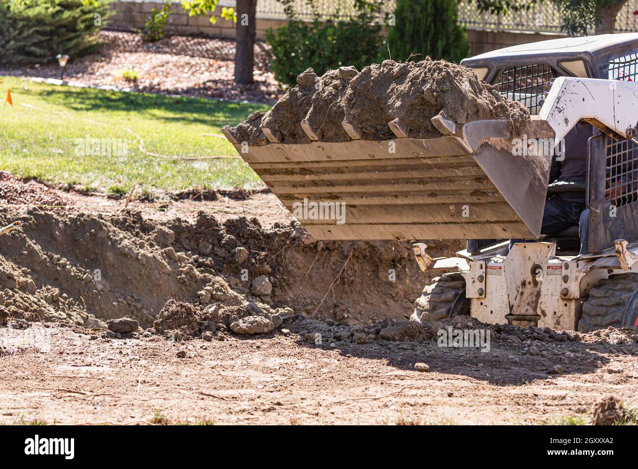 Small Bulldozer Digging In Yard For Pool Installation Stock Photo - Alamy