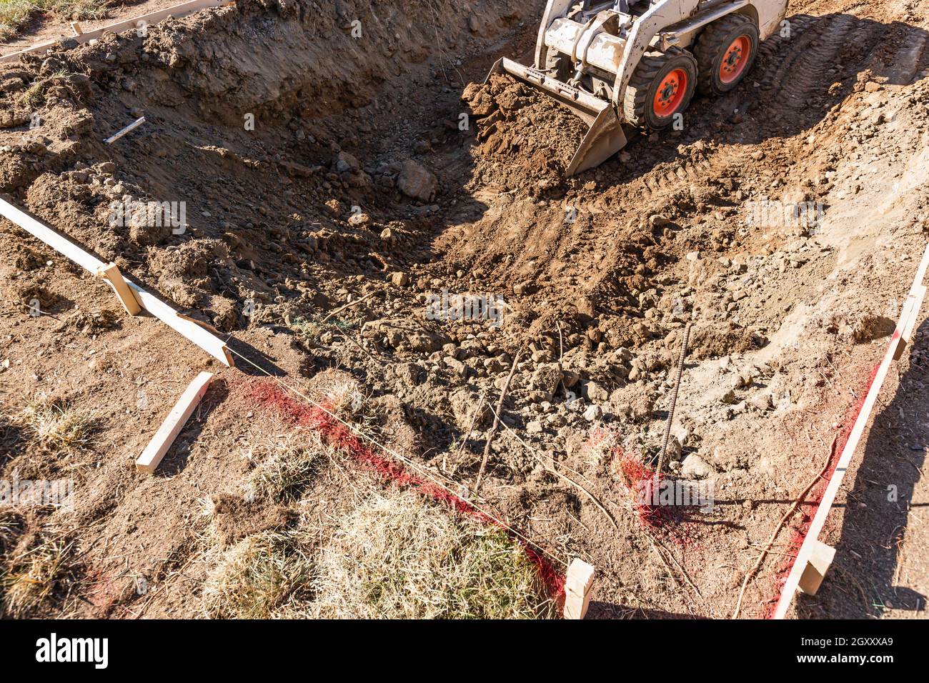 Small Bulldozer Digging In Yard For Pool Installation Stock Photo - Alamy