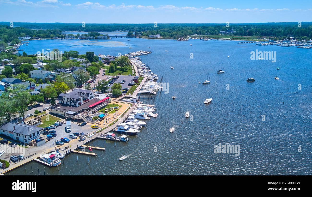 Docks along lake coast full of boats and ships sailing in water Stock ...