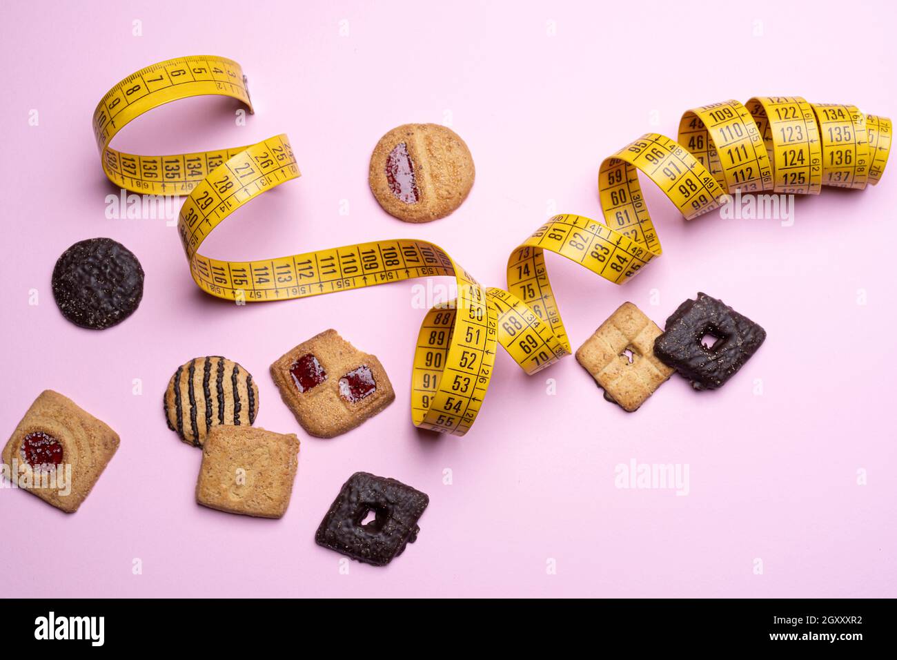 a tape measure between some cookies on a colored surface Stock Photo ...