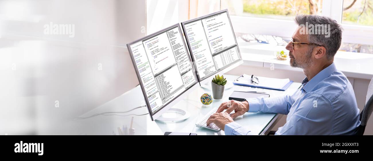 Programmer In Office Working On Multiple Computer Monitor Screens Stock ...