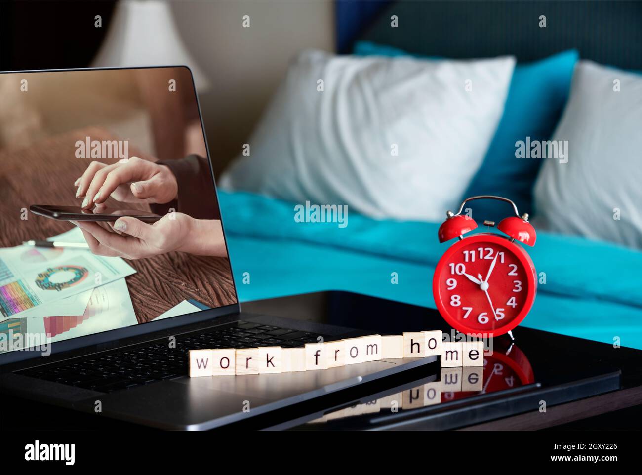 Work from home. Laptop with WFH wording and red Alarm clock 10 O'clock ...