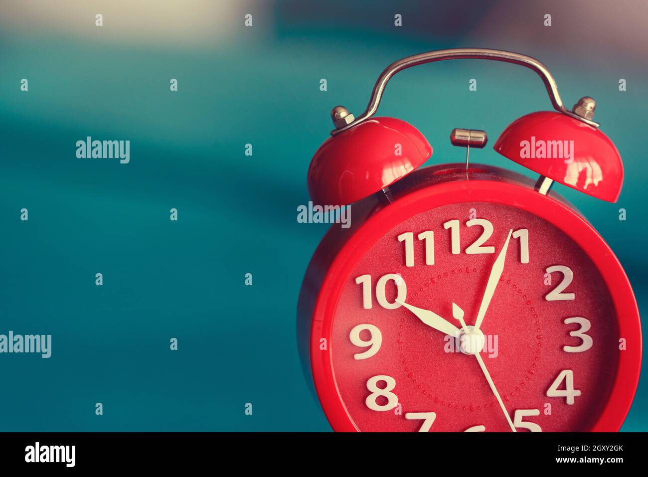 Closeup on clockwise. Face of red Alarm clock at 10 O'clock Stock Photo ...