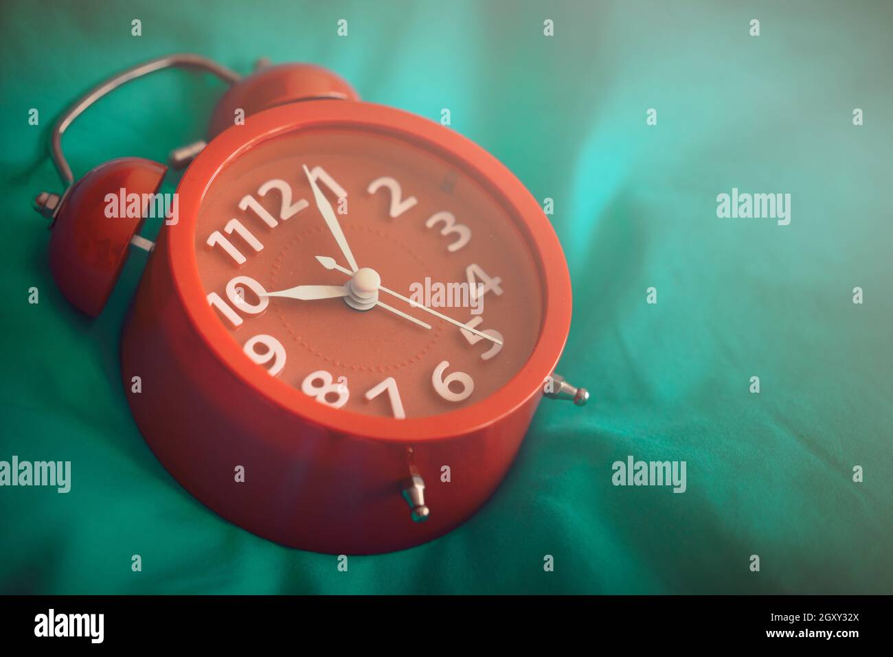 Closeup on clockwise. Face of red Alarm clock at 10 O'clock Stock Photo ...
