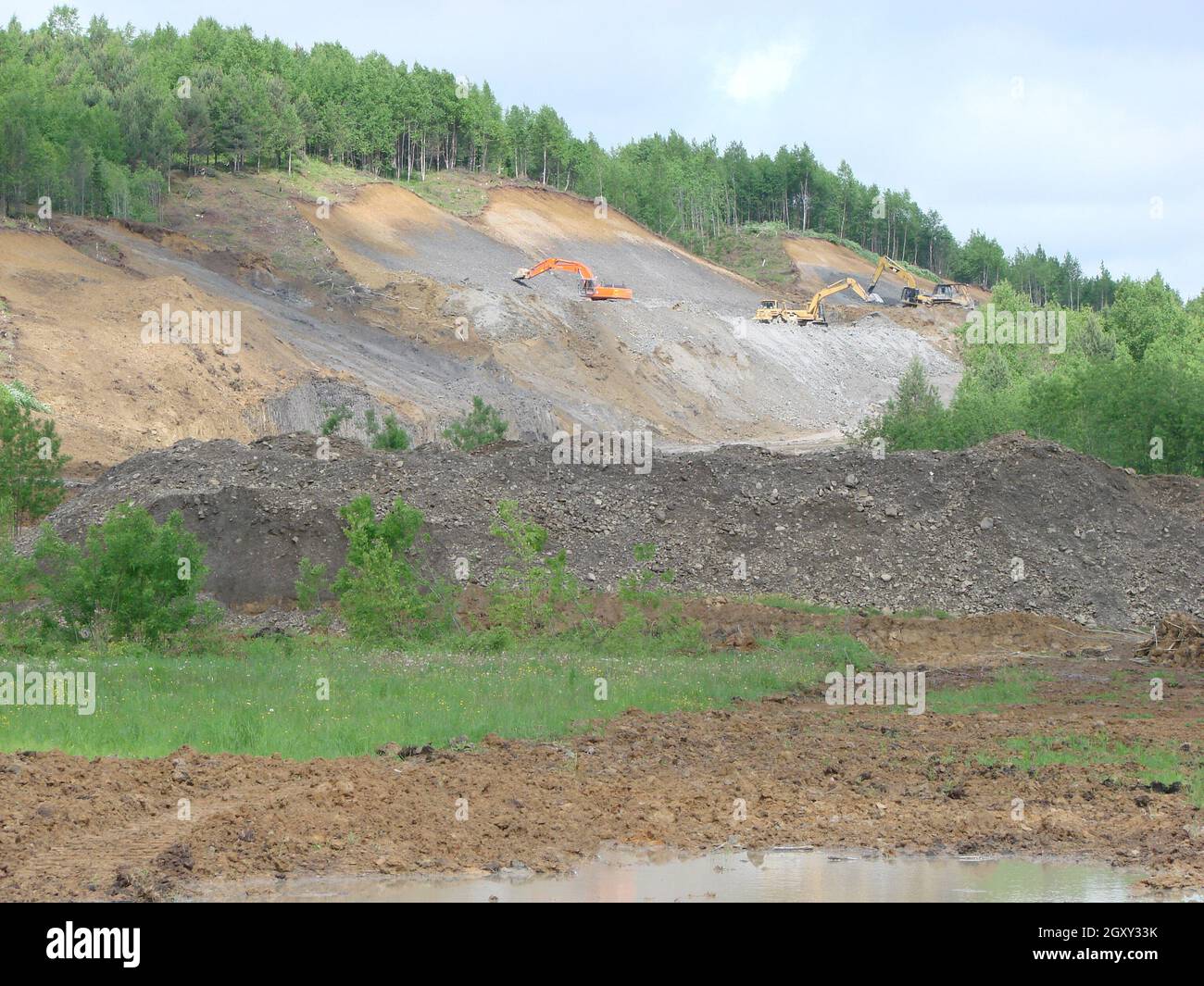 Excavation of a pit. Production of gray crushed stone for road powder ...