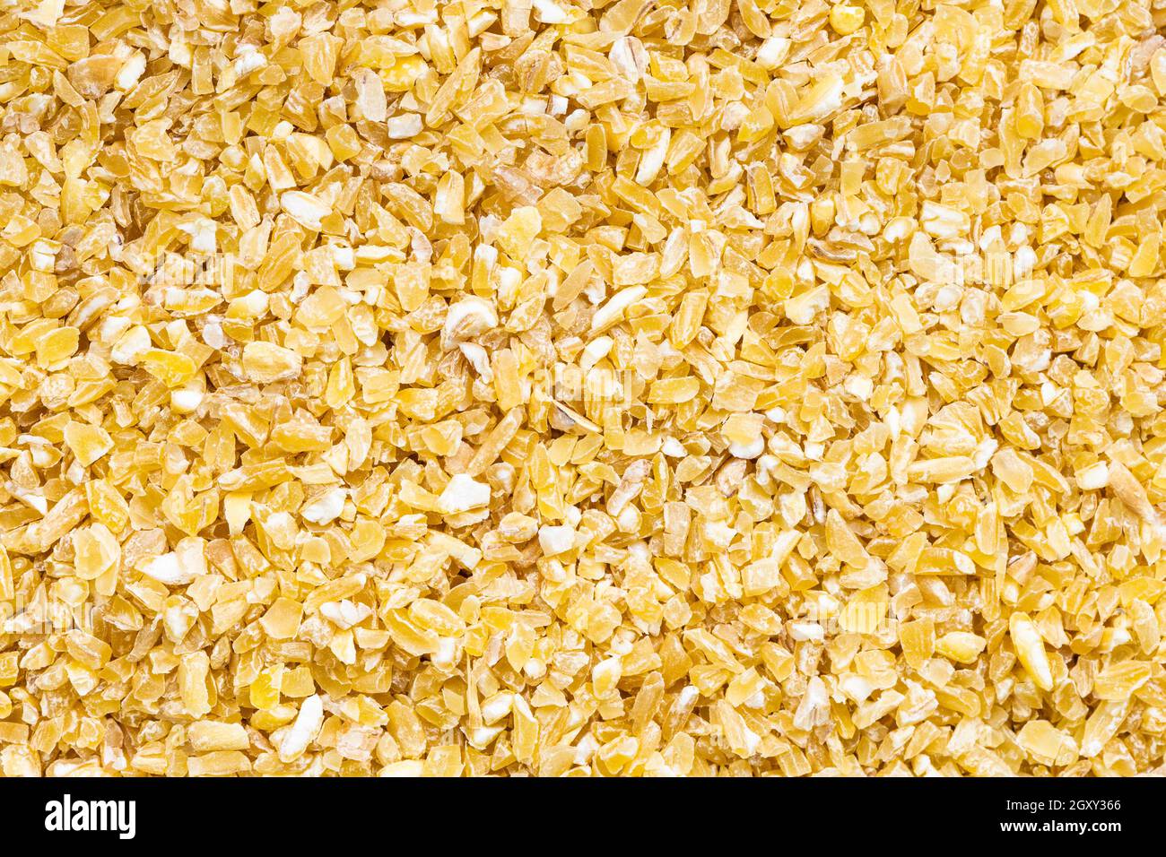 food background - uncooked crushed polished wheat grains Stock Photo ...