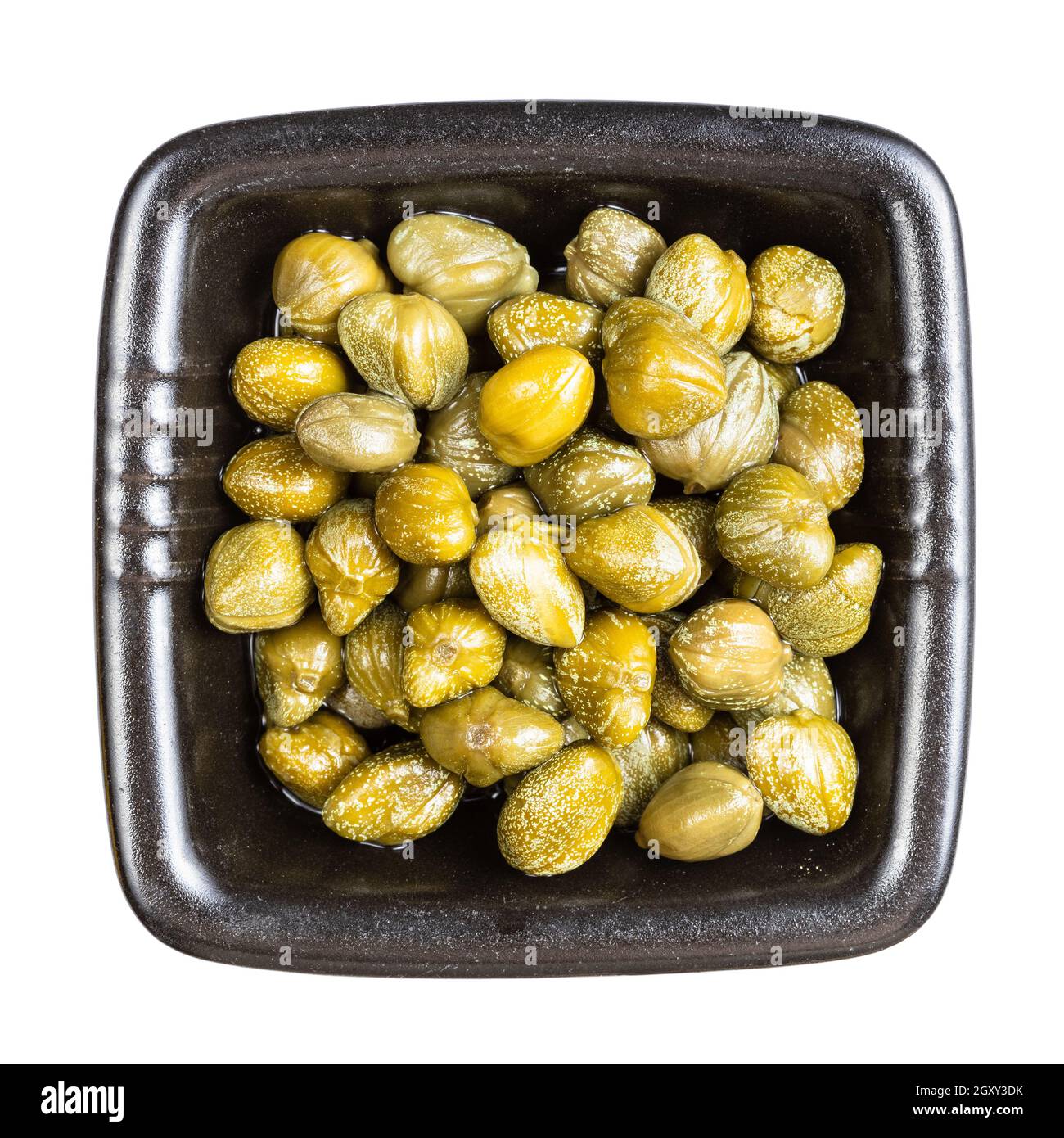 top view of pickled capers in black bowl isolated on white background ...
