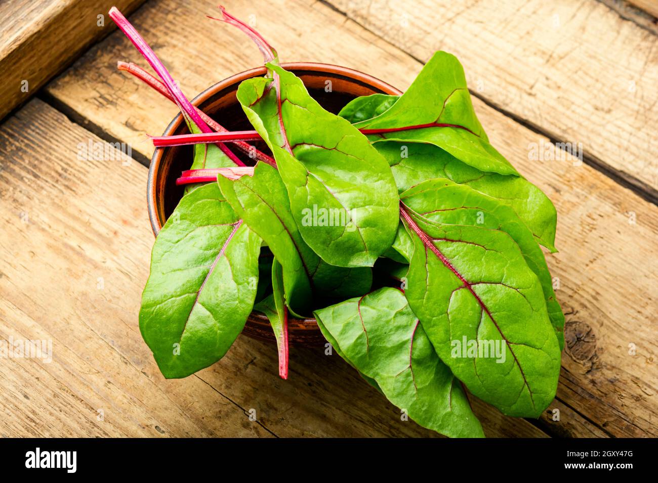 Raw chard leaves on rustic wooden background.Salad leaves Stock Photo ...