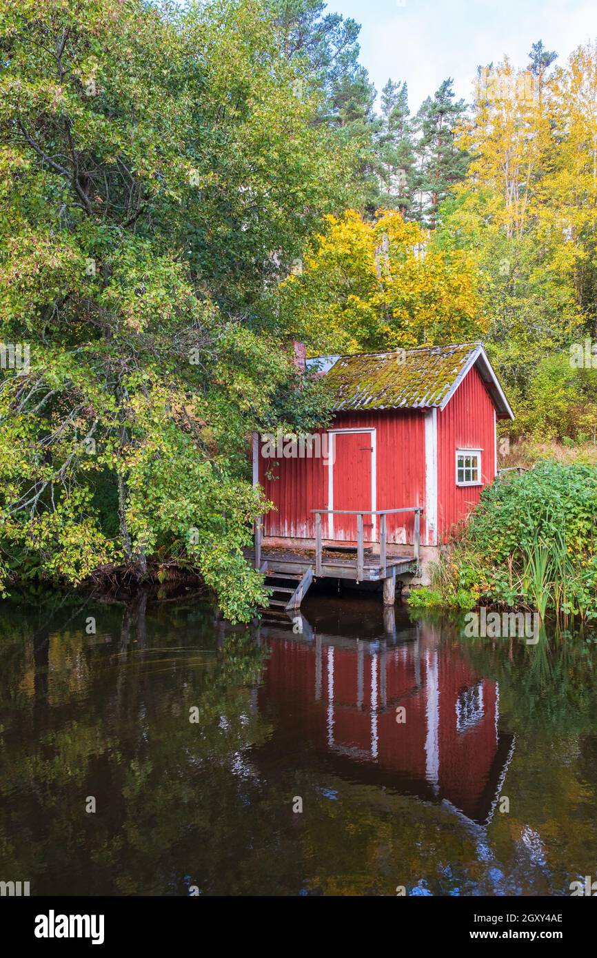 Idyllic cottage by the water with a jetty in the fall Stock Photo - Alamy