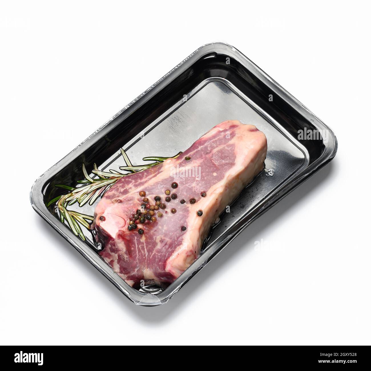 Raw New York beef steak is packed in a plastic container and vacuum ...