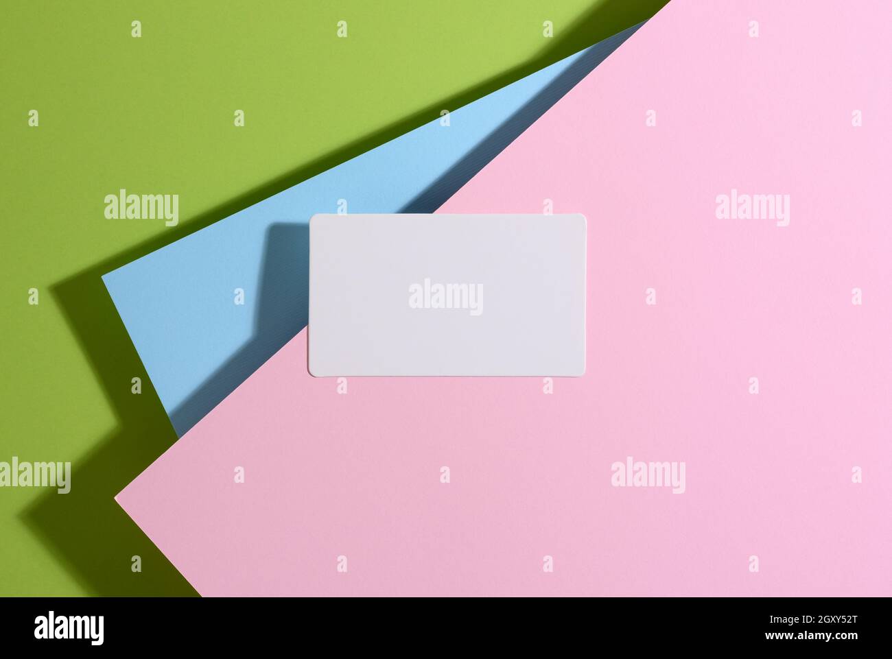 blank rectangular business card lies on a modern bright green ...