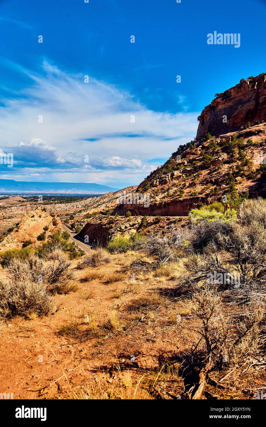 Vertical of desert with rocky mountains and road Stock Photo - Alamy
