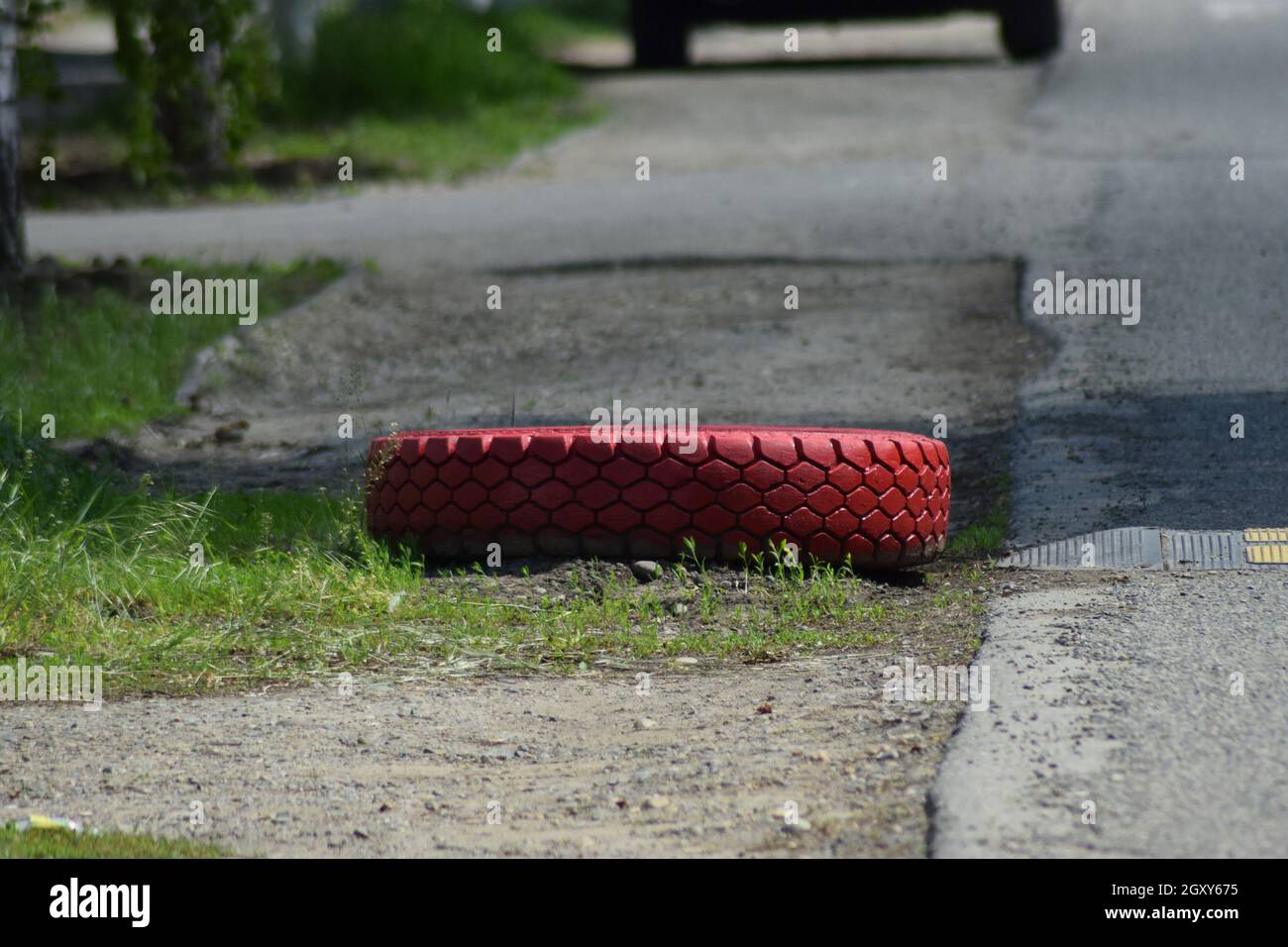 Red tread wheels on the side of the road. Wheel Using a delimiter Stock ...
