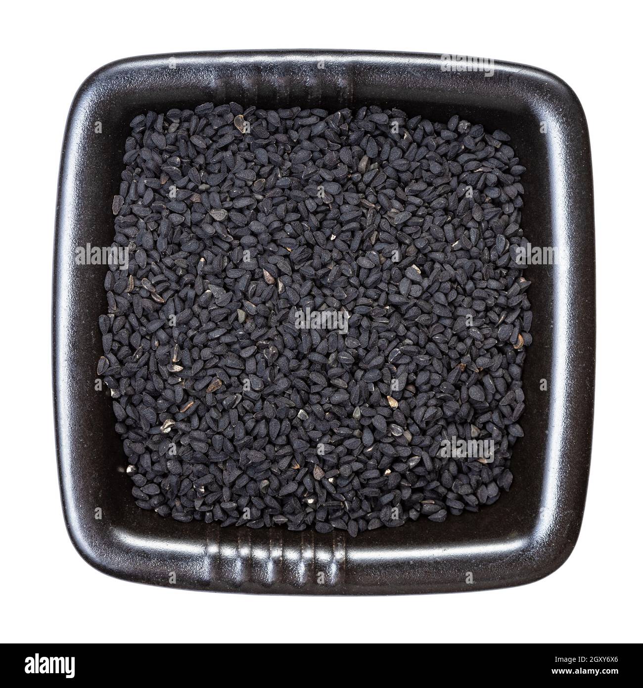 top view of Nigella sativa seeds (black caraway) in black bowl isolated ...