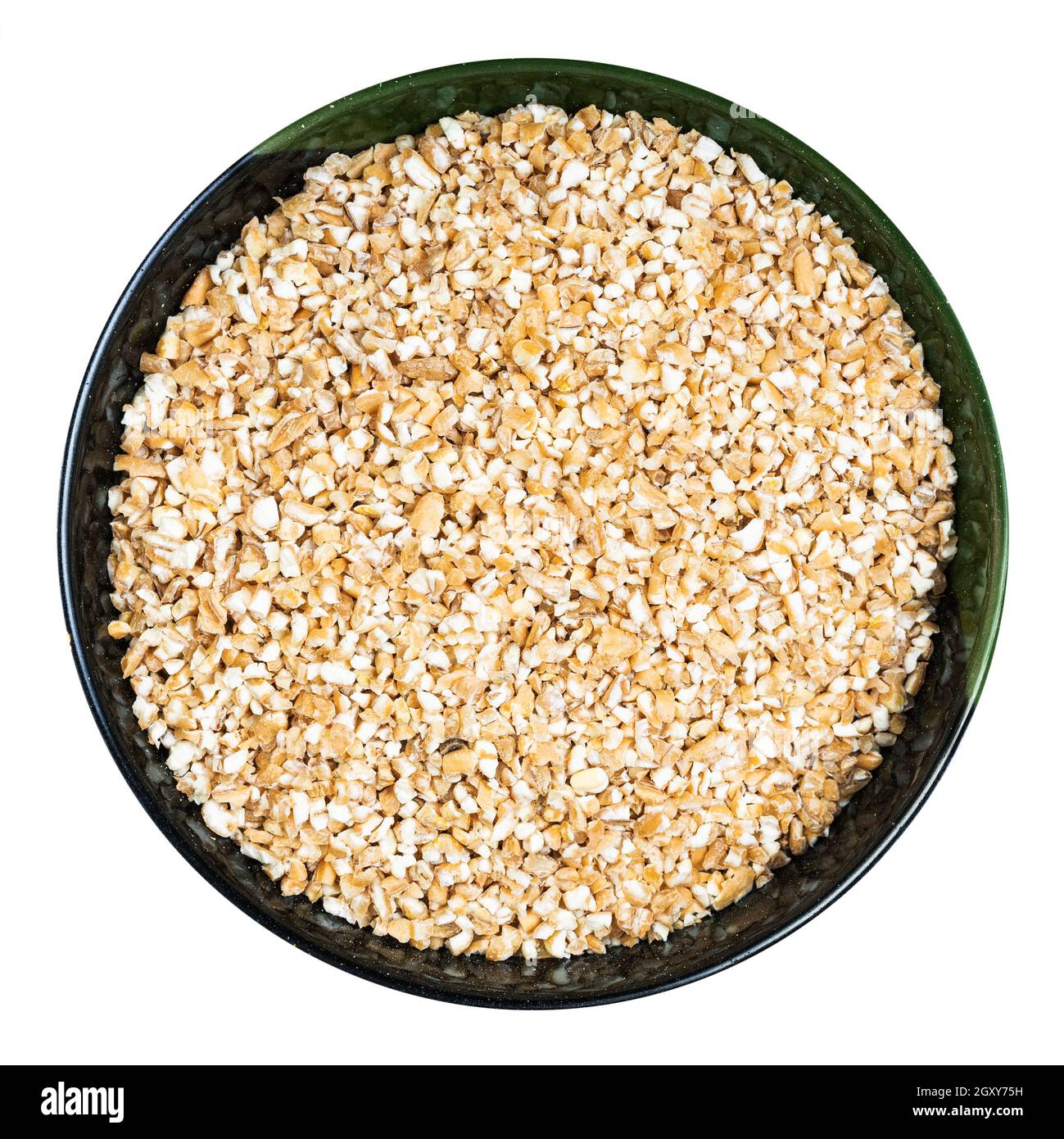 top view of wheat groats (crushed partly hulled wheat grains) in round ...