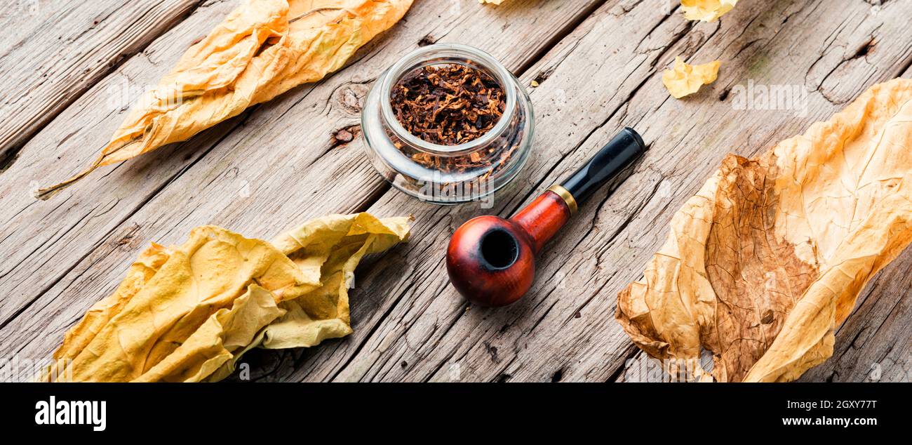 Tobacco pipe, tobacco leaf and pipe tobacco.Smoking pipe on rustic ...