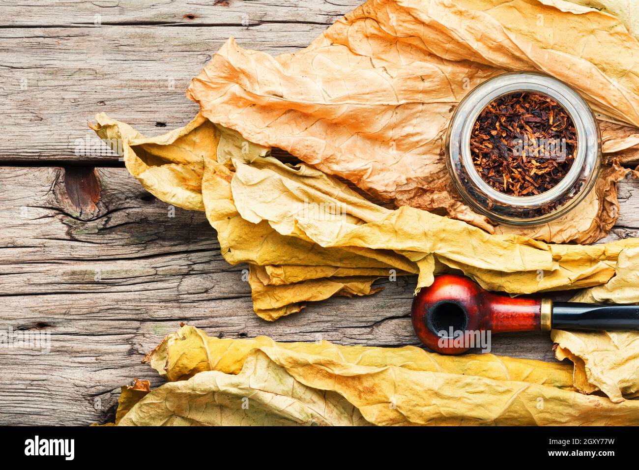 Tobacco pipe, tobacco leaf and pipe tobacco.Smoking pipe on rustic ...