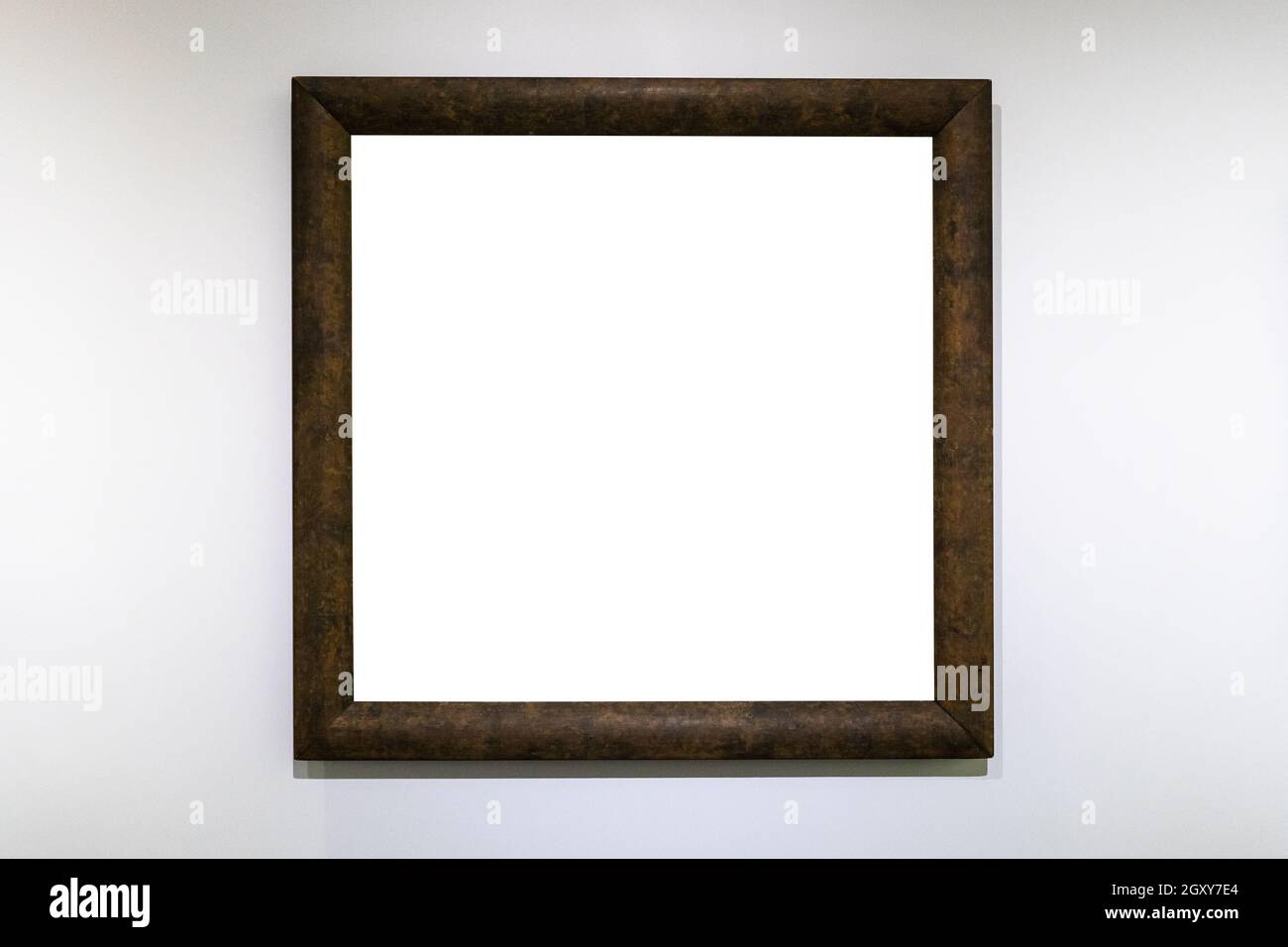 square dark brown picture frame with cutout canvas on white wall Stock ...