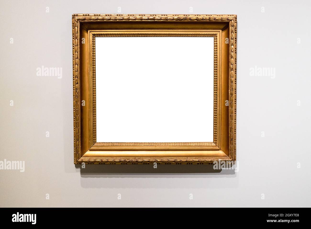 old wide golden picture frame with cutout canvas on gray wall Stock ...