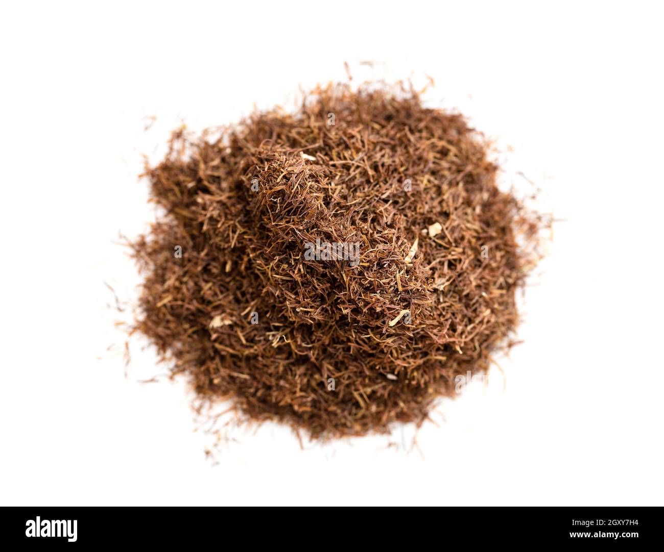 top view of pile of grinded dried corn silk close up on white plate ...