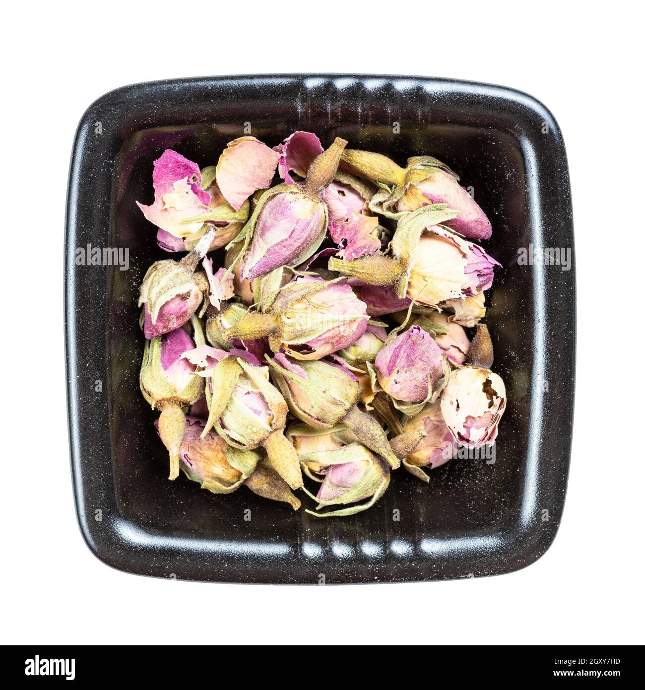 top view of old dried rosebuds in black bowl isolated on white ...