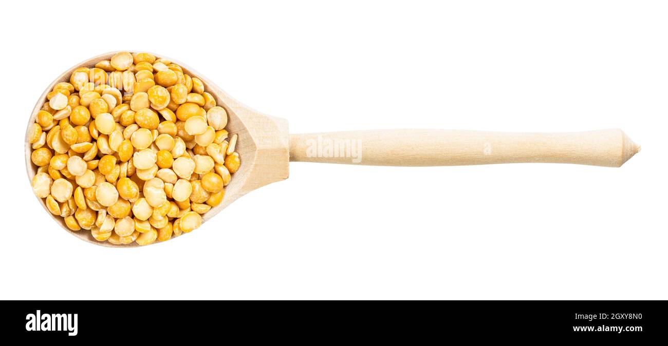 top view of wood spoon with dried split yellow peas isolated on white ...