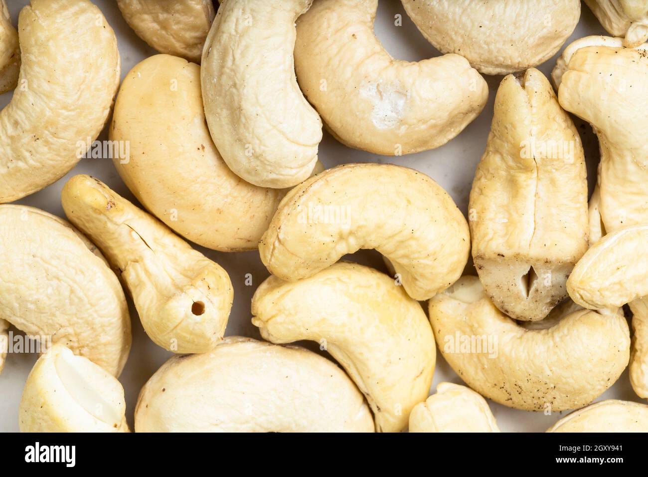 food background - many raw cashew seeds Stock Photo - Alamy
