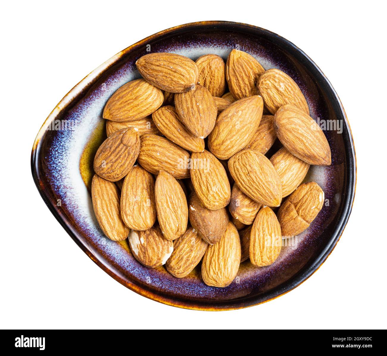 top view of raw almond seeds in ceramic bowl isolated on white ...