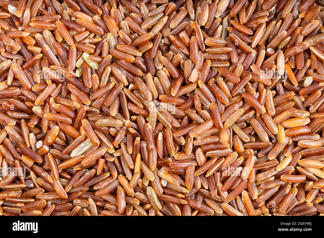 food background - many raw red rice grains close up Stock Photo - Alamy