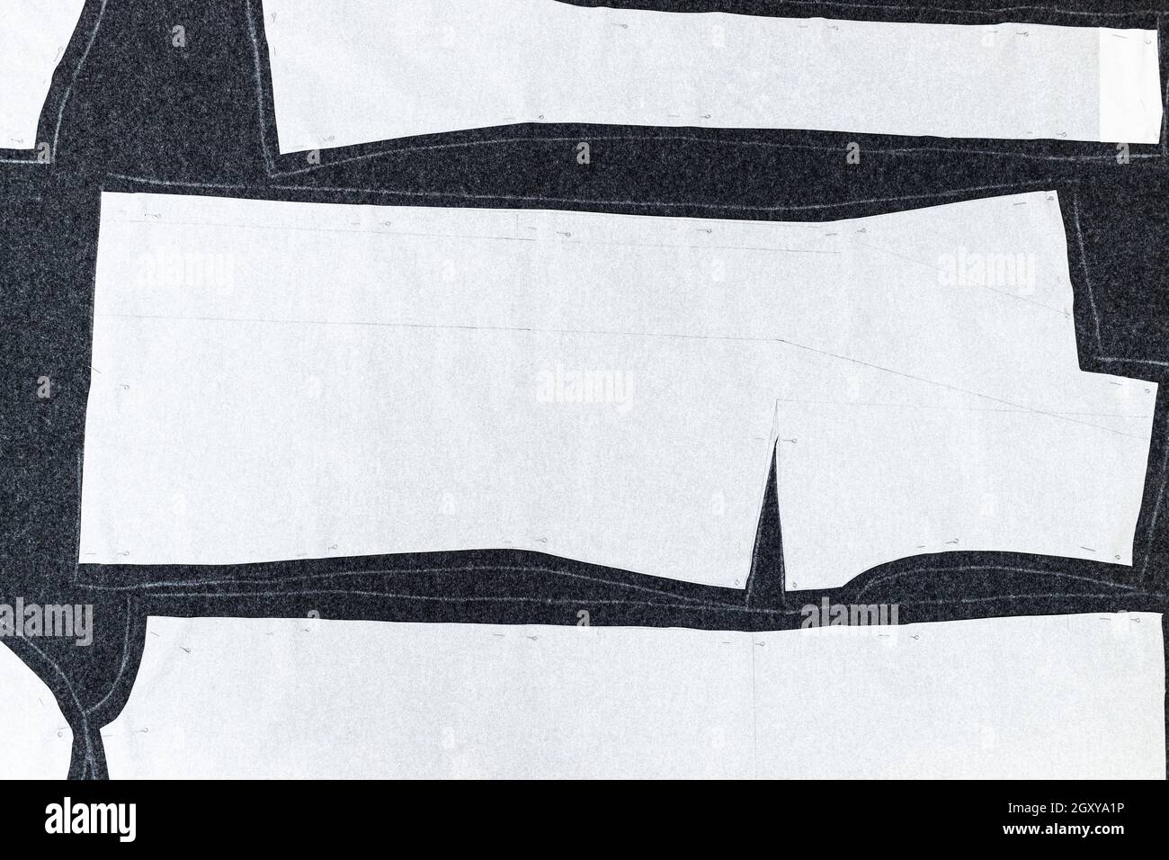 paper layout of sewing patterns of dress on dark fabric Stock Photo - Alamy