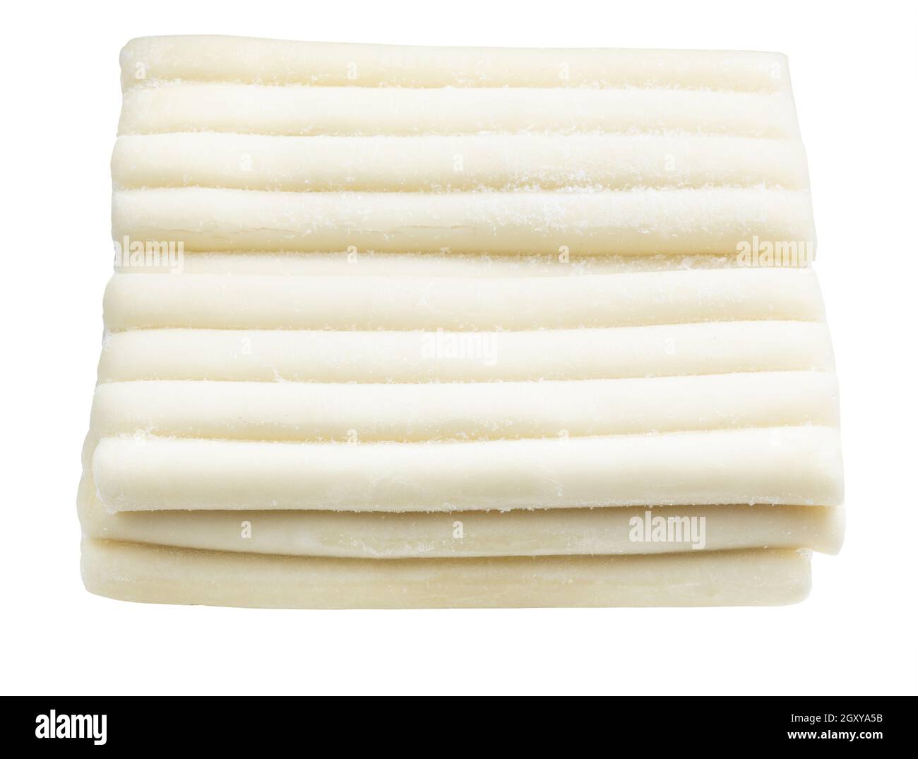 block of raw frozen tteokbokki (korean rice cakes) isolated on white ...