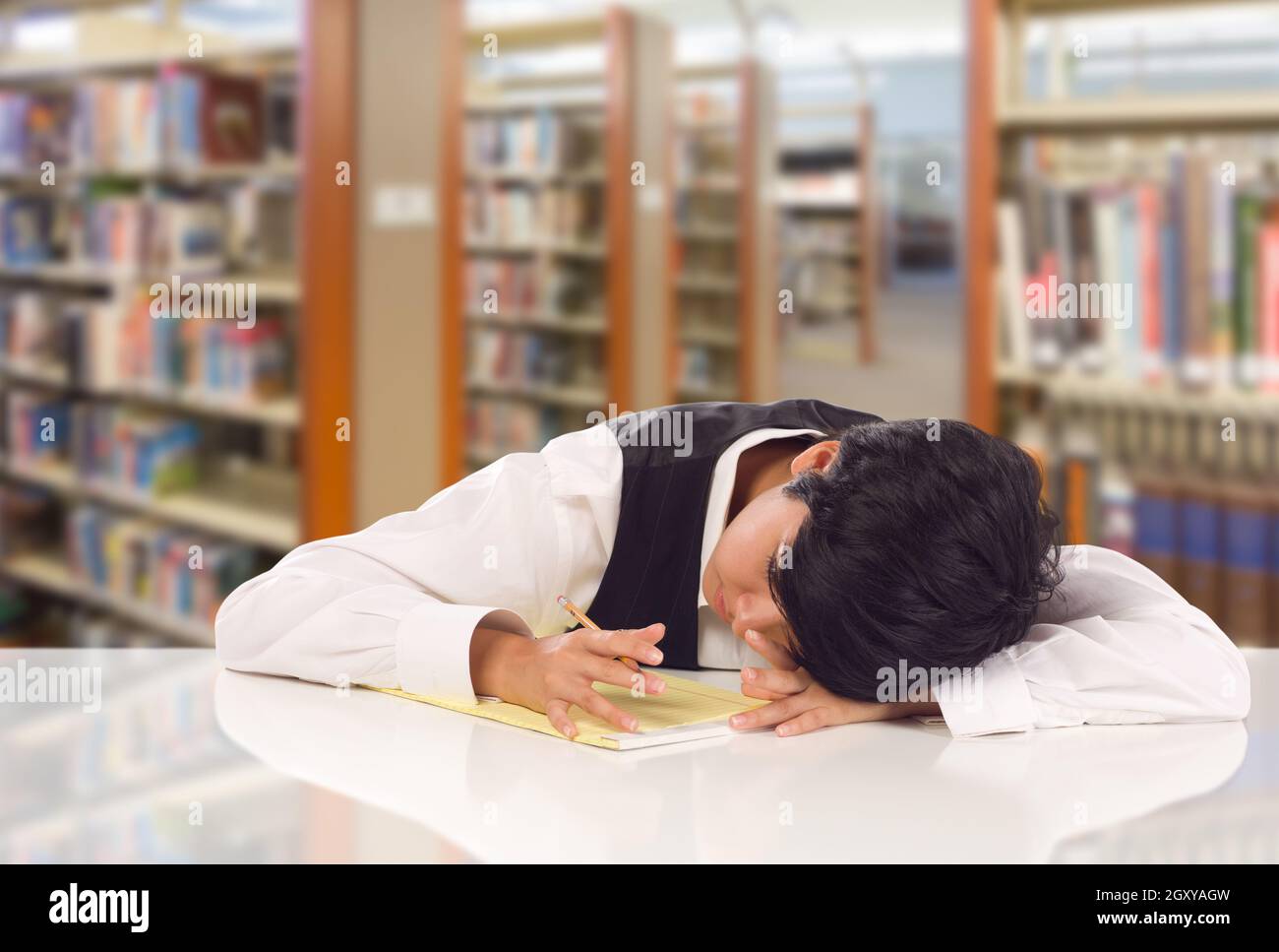 Young Female Mixed Race Student Stressed and Frustrated In Library with ...