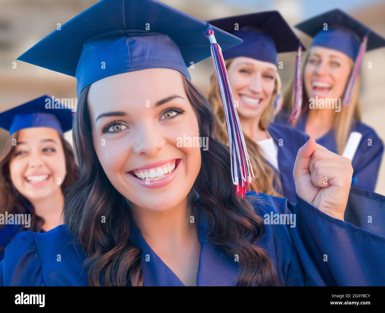 Happy Graduating Group of Girls In Cap and Gown Celebrating on Campus ...