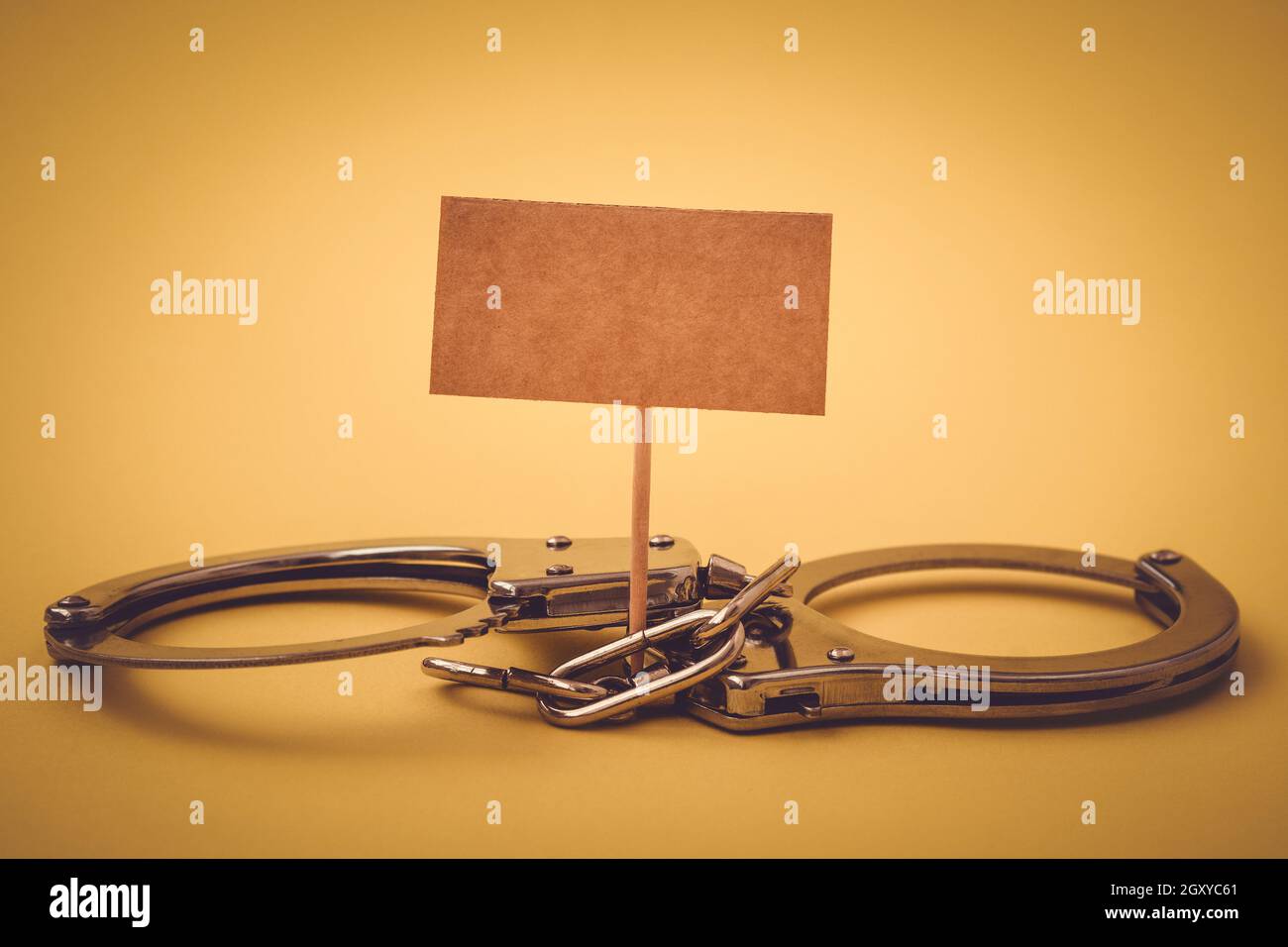 Handcuffs and blank banner mock up on wood stick. Conceptual image ...